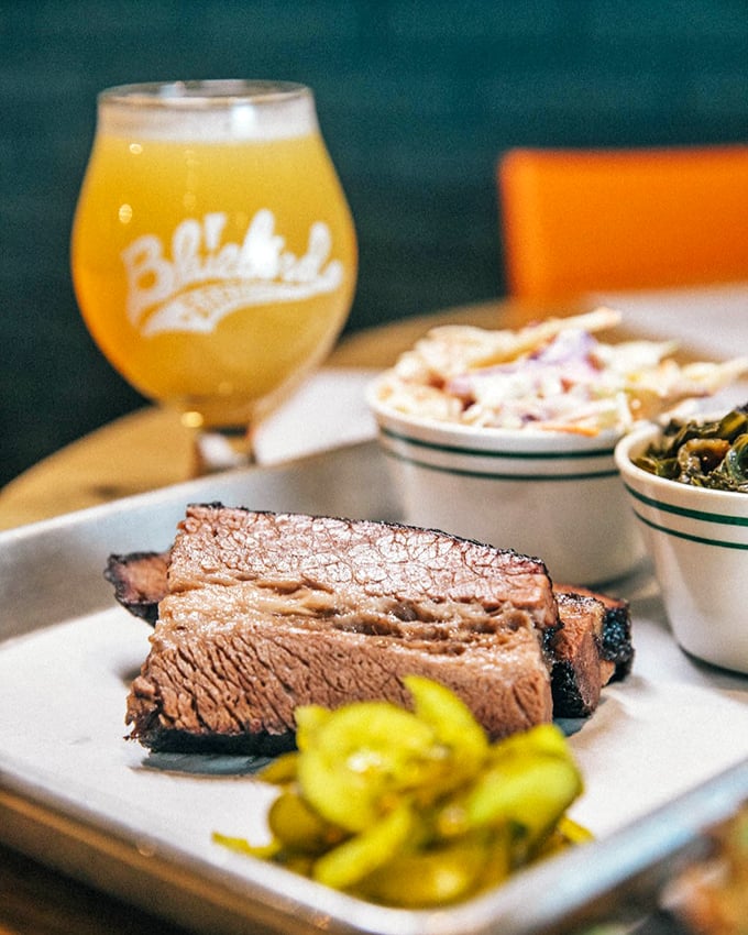 The perfect bite awaits! Juicy brisket, tangy pickles, and a cold brew &ndash; it's like a flavor party in your mouth.