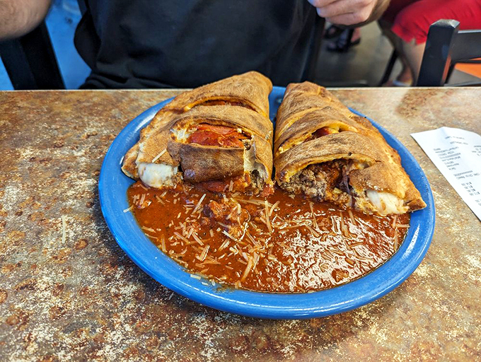 Holy calzone, Batman! This stuffed wonder is like a pizza doing yoga &ndash; folded over and bursting with cheesy, saucy goodness.