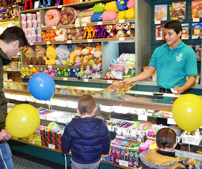 The keeper of the castle's treasures stands ready to exchange your hard-earned tickets for prizes. Choose wisely, young squire &ndash; that giant stuffed dragon won't fit in the minivan.