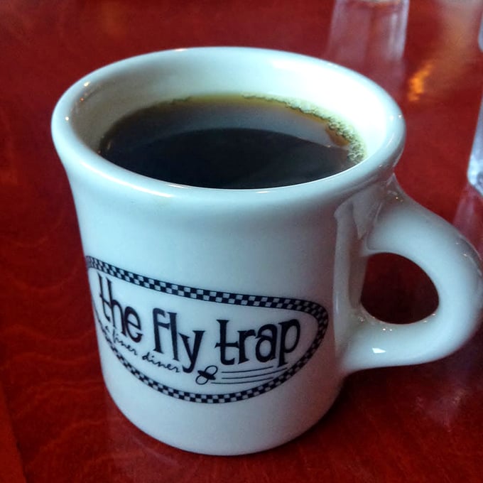 Wake up and smell the coffee! The Fly Trap's signature mug promises a jolt of joy with every sip.