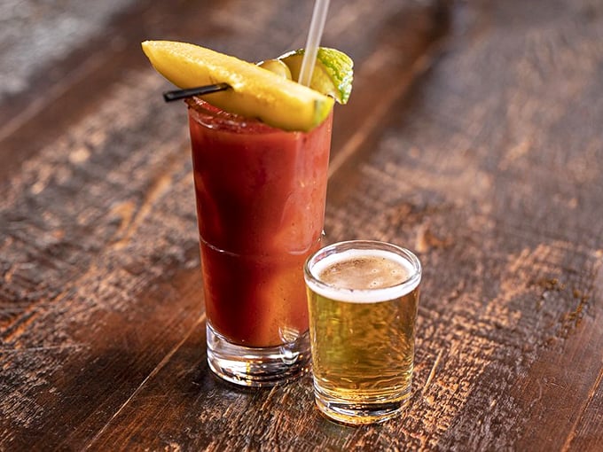 Cheers to good taste! A zesty Bloody Mary and a crisp beer stand ready to complement your barbecue feast. It's like a party in a glass!