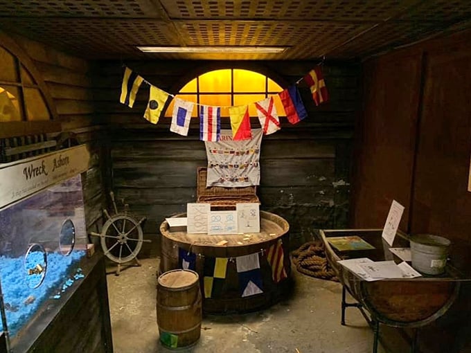 Ahoy there, landlubbers! This corner of the museum is like a pirate's attic sale, complete with nautical flags and a treasure map (X marks the spot!).