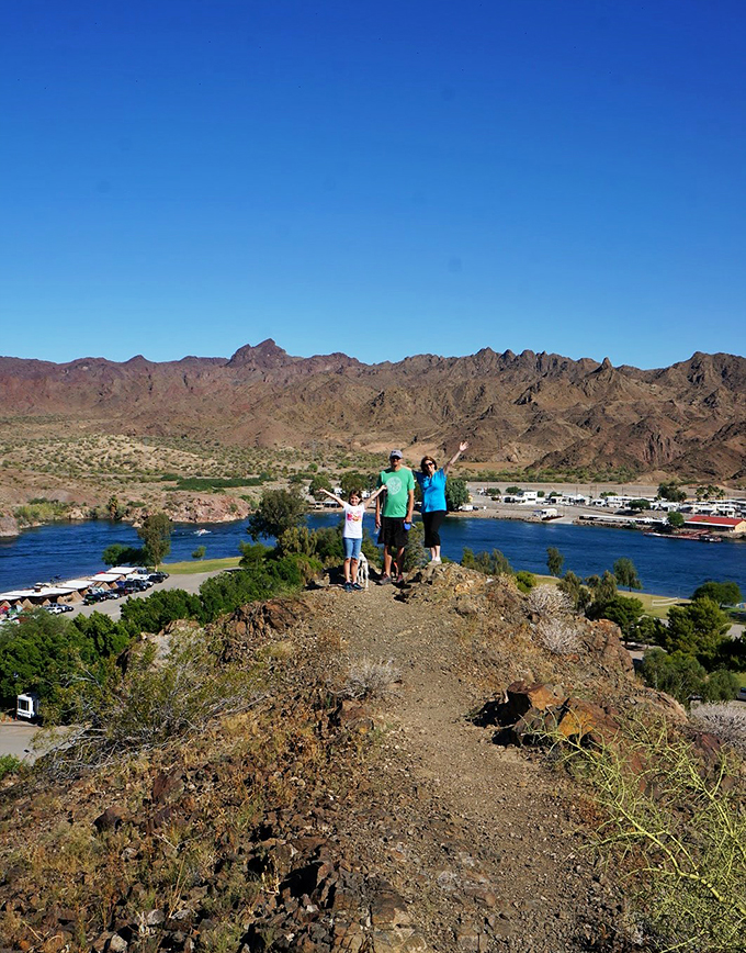 Top of the world, Ma! Hikers strike a victory pose atop Buckskin's trails. The view's so good, even your smartphone camera can't mess it up.