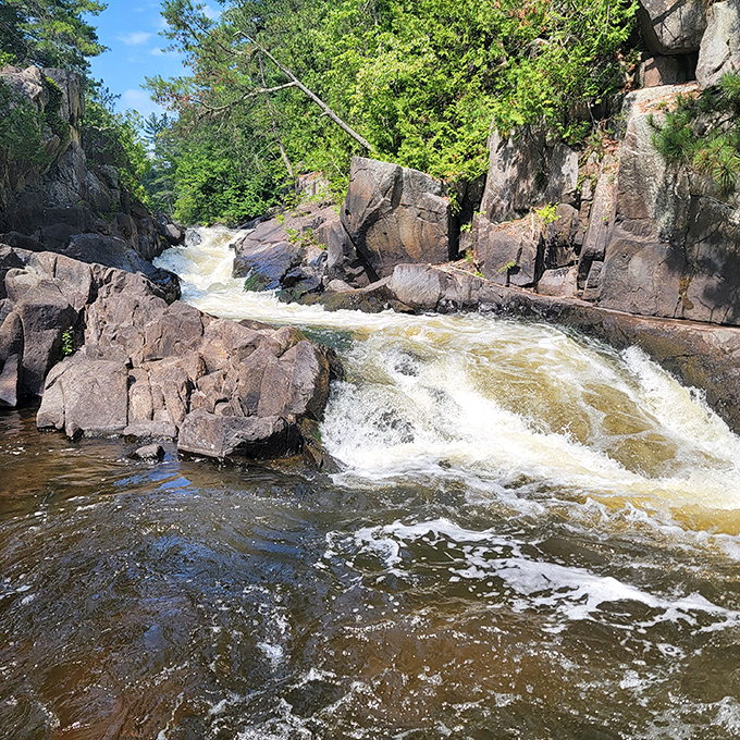 Dave's Falls crashes over that dark volcanic rock with enough power to remind you that nature doesn't mess around.