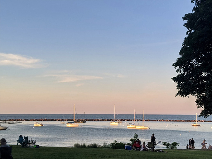 "Forget rush hour &ndash; here's a traffic jam I can get behind!" Sailboats dot the horizon as visitors gather to witness a breathtaking lakeside sunset.