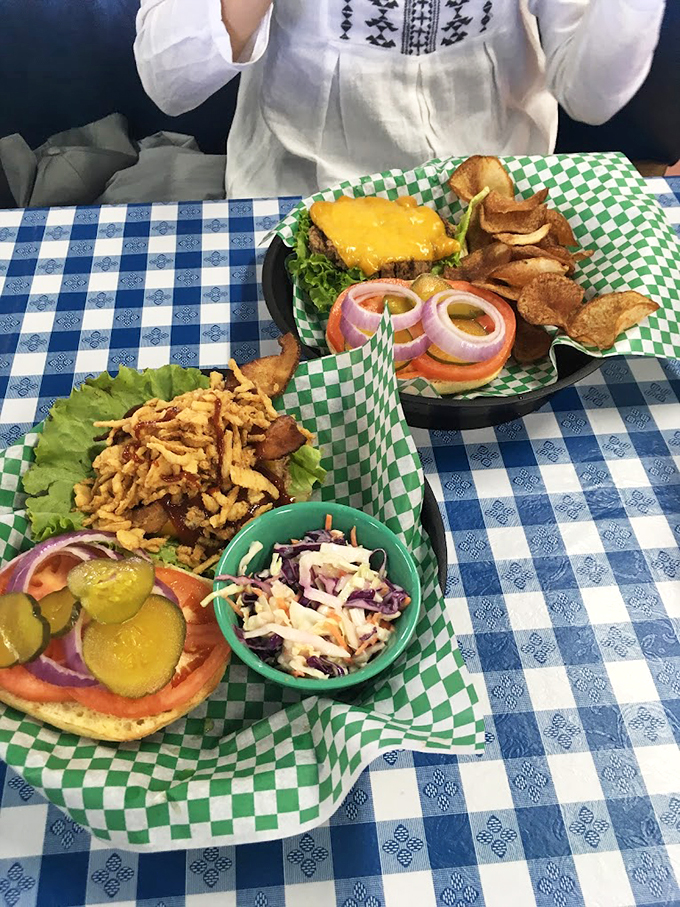 Behold, the all-American feast! These burgers and sides aren't just a meal, they're a delicious slice of Americana served on a blue-checkered canvas.