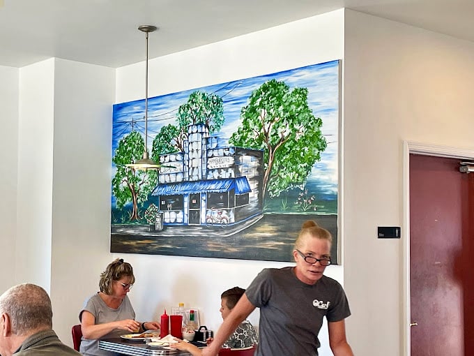 Who needs a window when you've got art like this? It's like someone painted my dream diner, complete with that classic blue awning.