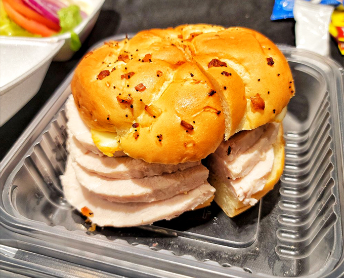 Turkey sandwich, you say? More like a poultry palace between bread, complete with a pickle scepter and a side of golden fries.