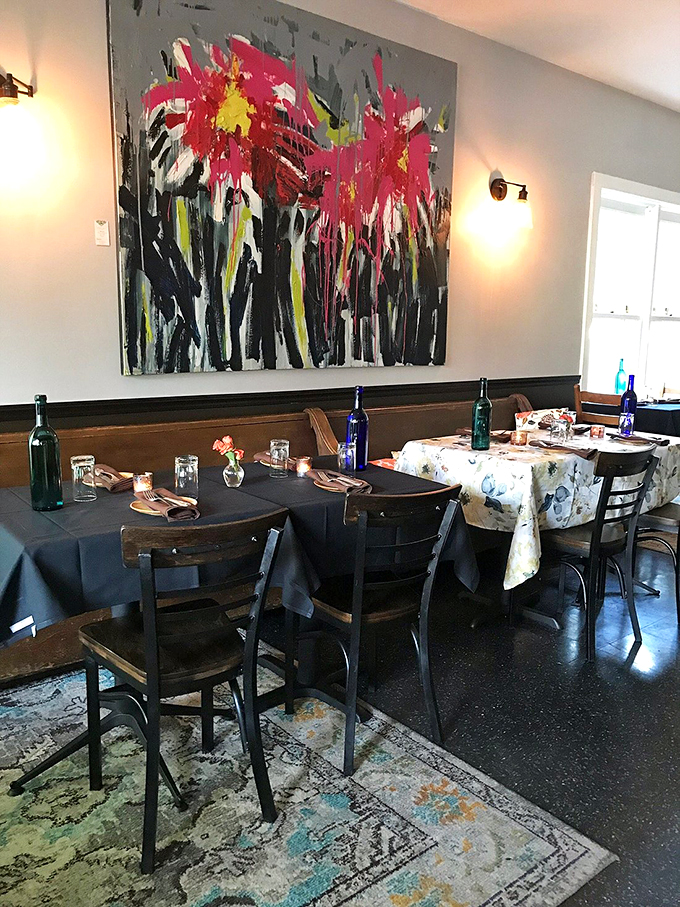 Dine under a burst of color! This vibrant artwork adds a dash of whimsy to your meal, like eating in a chic art gallery.
