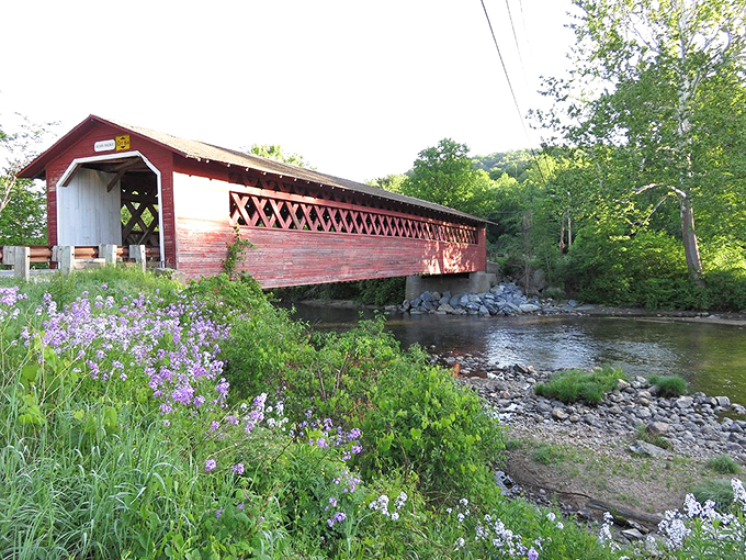 Spring has sprung, and this bridge is ready for its close-up! Purple flowers add a pop of color to this postcard-perfect scene.