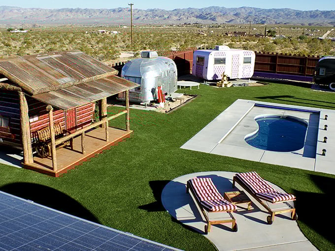 Welcome to wonderland! Hicksville Trailer Palace greets you with a Joshua tree silhouette, promising desert adventures and retro charm.