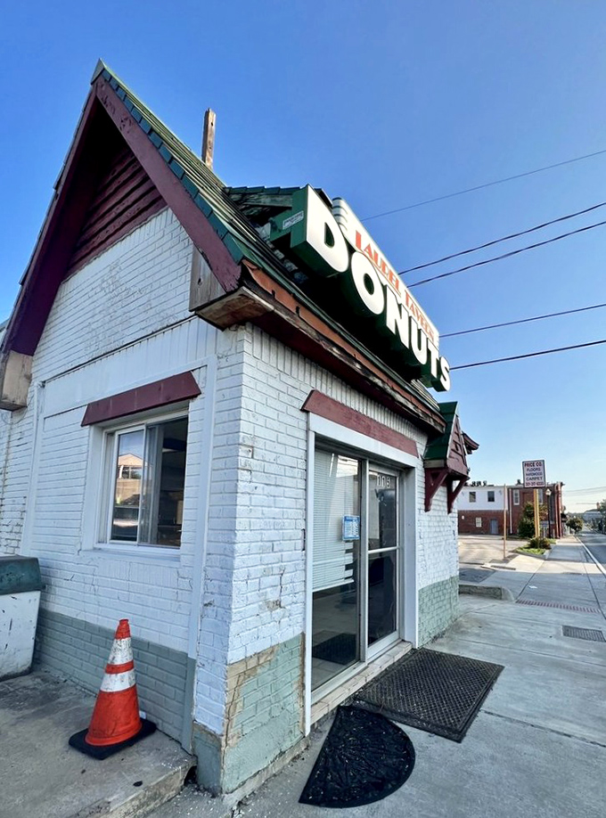 A donut lover's beacon of hope! This charming white brick building with its bold "DONUTS" sign is like a lighthouse guiding sugar-seekers to sweet salvation.