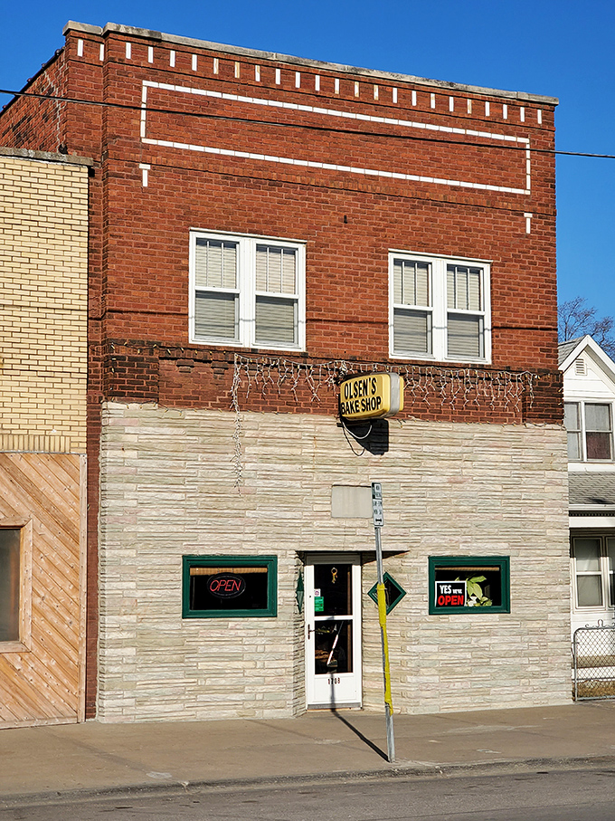 A beacon of sweetness! Olsen's Bake Shop stands proud, its vintage sign promising sugary delights within those whitewashed walls.
