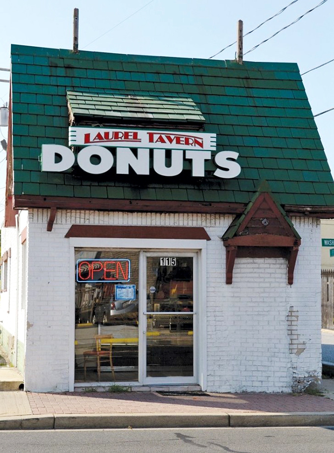 A donut lover's beacon of hope! This charming white brick building with its bold "DONUTS" sign is like a lighthouse guiding sugar-seekers to sweet salvation.