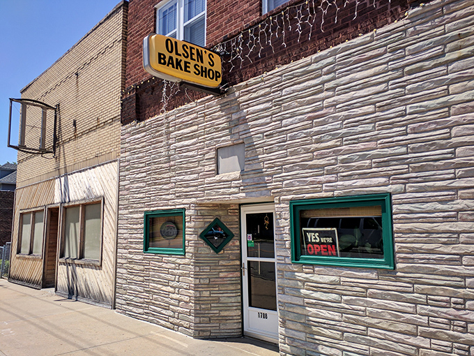 A beacon of sweetness! Olsen's Bake Shop stands proud, its vintage sign promising sugary delights within those whitewashed walls.