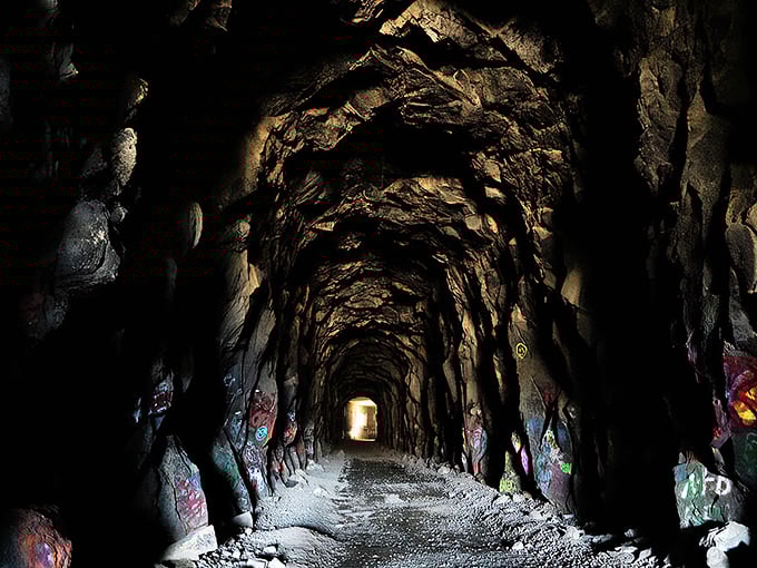 Step into a time warp! This graffiti-adorned tunnel is like a portal to the past, with a splash of modern street art flair.