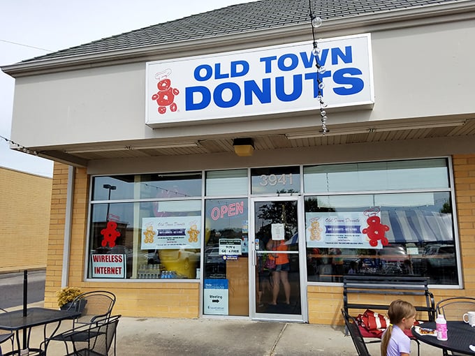 Welcome to donut paradise! Old Town Donuts beckons with its cheery red sign, promising sweet delights and a slice of small-town charm.