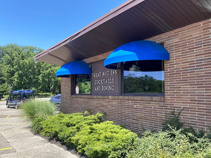 Blue awnings and brick walls: The What-Not Inn beckons like a cozy oasis in the Michigan countryside. Come for the cocktails, stay for the charm!