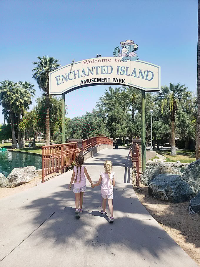 Welcome to Enchanted Island Amusement Park. Palm trees frame the scene, creating an oasis-like atmosphere that promises fun and adventure ahead.
