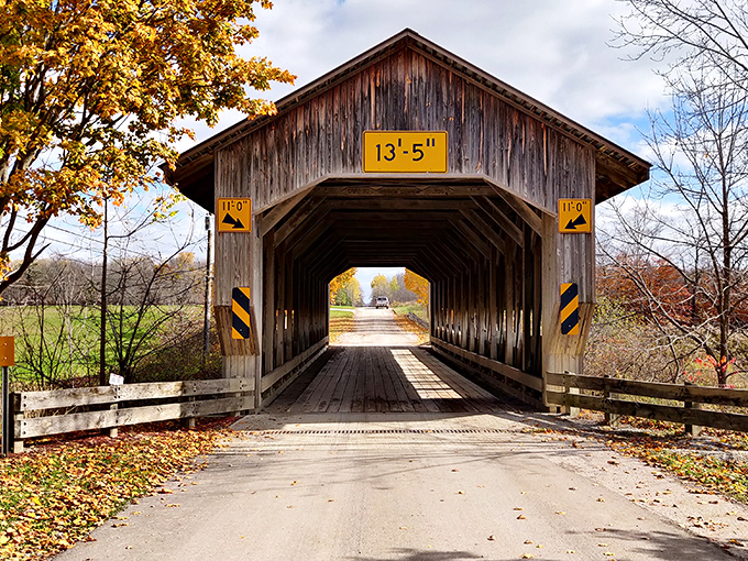 "Autumn's golden embrace!" This covered bridge isn't just crossing a creek; it's time-traveling through a Rockwell painting come to life.