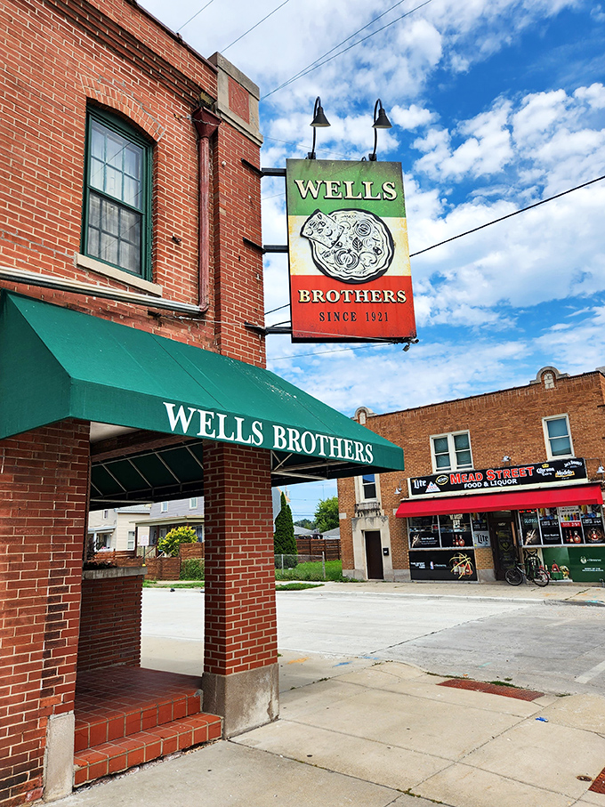 A slice of history served with a side of neon! Wells Brothers' iconic sign has been guiding pizza pilgrims since 1921, proving some things really do get better with age.