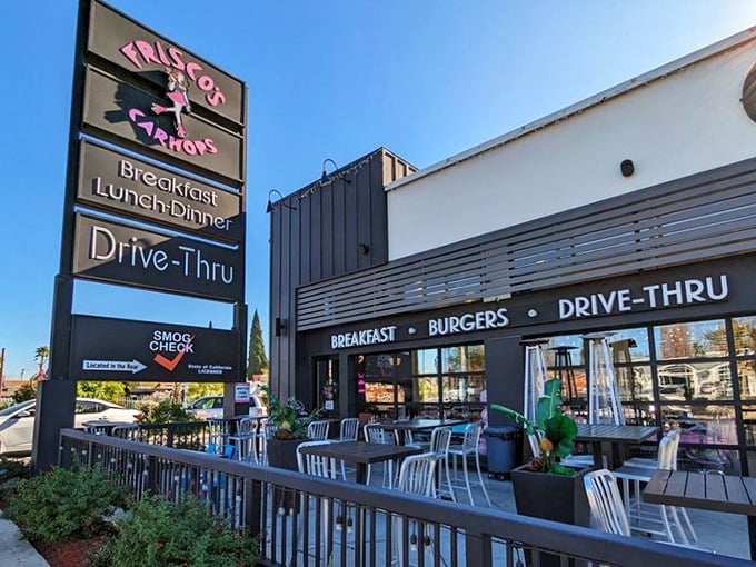 Step back in time! Frisco's neon sign beckons like a beacon from the past, promising burgers, shakes, and a hefty dose of nostalgia.