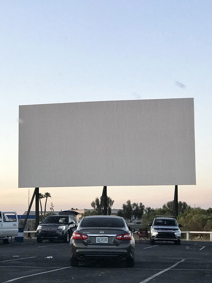 Twilight magic at the drive-in! As dusk settles, the giant screen awakens, promising a night of cinematic wonder under the stars.