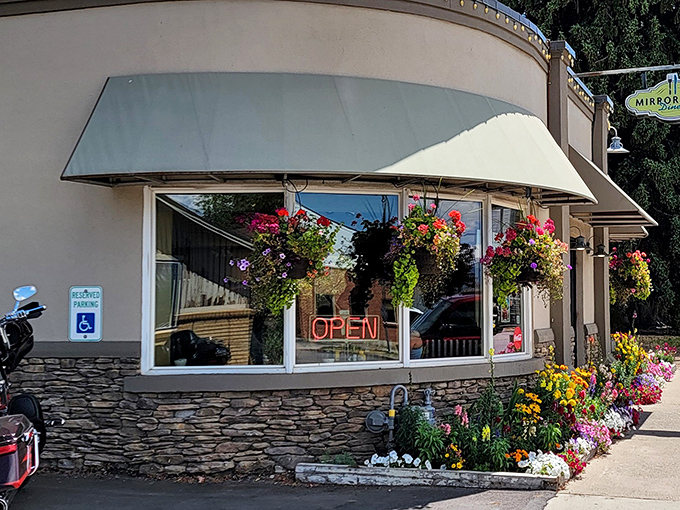 A floral welcome that's prettier than your grandma's Sunday best! Mirror Lake Diner's exterior blooms with charm, promising a feast for both eyes and stomach.
