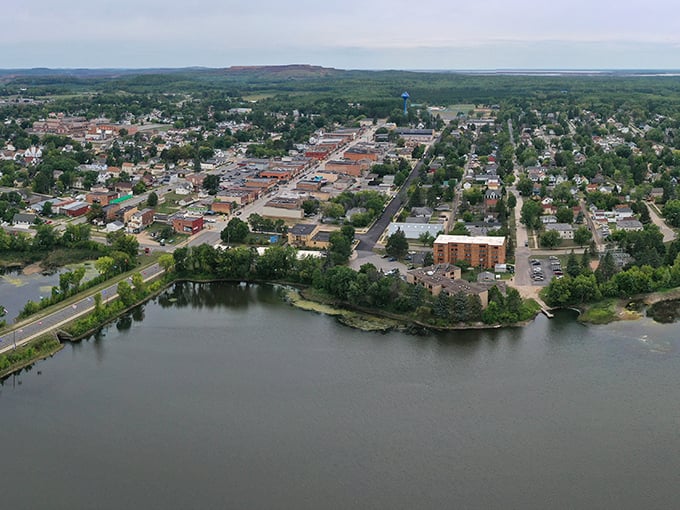 Chisholm: Where Main Street meets Mother Nature. This aerial view showcases the town's perfect blend of urban charm and natural beauty, like a Norman Rockwell painting come to life.