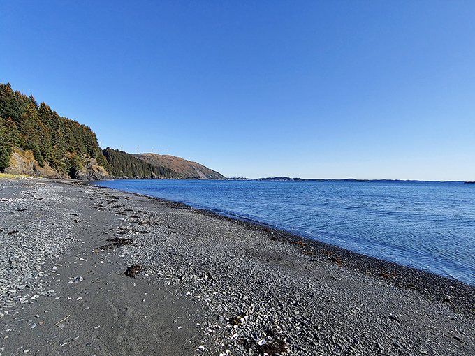 A serene shoreline stretching endlessly, where blue horizons meet peaceful waters and dreams drift as freely as the waves.