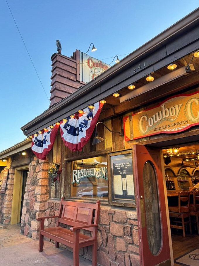 Howdy, partner! This ain't your average saloon – it's a time machine disguised as a restaurant, complete with patriotic bunting and a welcoming wooden bench.