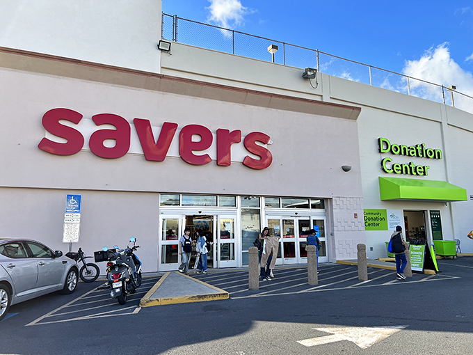 Welcome to bargain paradise! Savers' exterior promises a treasure trove of deals, nestled between palm trees and parked cars. It's like a retail oasis in the urban jungle.