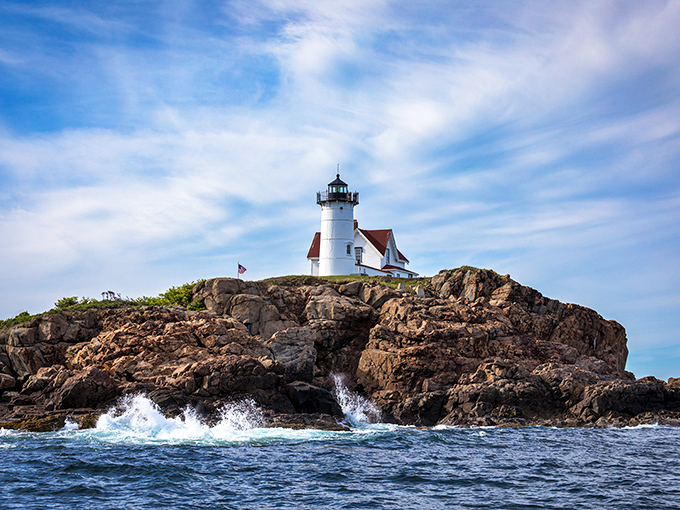 A postcard come to life! Nubble Lighthouse stands proud on its rocky perch, daring the waves to even think about messing with Maine's coast.