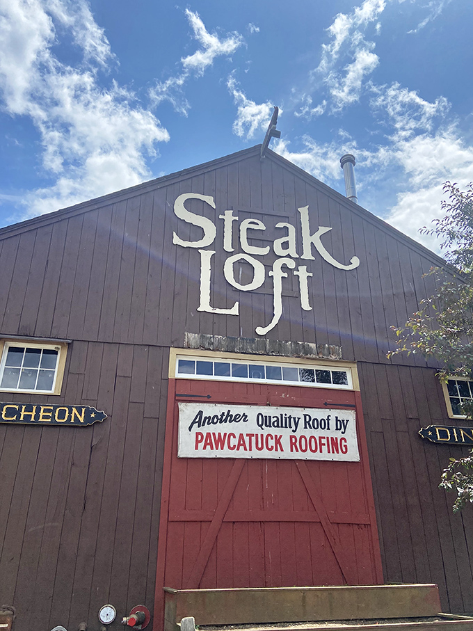 A barn-like beacon of beefy bliss! This rustic exterior promises a cozy culinary adventure within, complete with a vibrant red door that practically screams "Come on in, carnivores!"