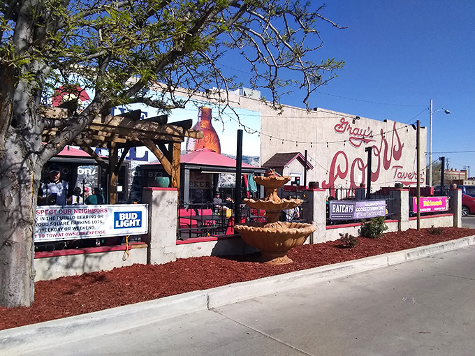 Welcome to flavor town! Gray's Coors Tavern's exterior promises a journey through time and taste, with its vintage charm and inviting beer garden.
