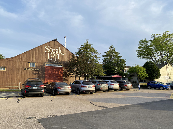 A barn-like beacon of beefy bliss! This rustic exterior promises a cozy culinary adventure within, complete with a vibrant red door that practically screams "Come on in, carnivores!"