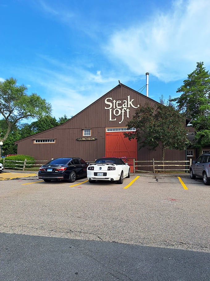 A barn-like beacon of beefy bliss! This rustic exterior promises a cozy culinary adventure within, complete with a vibrant red door that practically screams "Come on in, carnivores!"