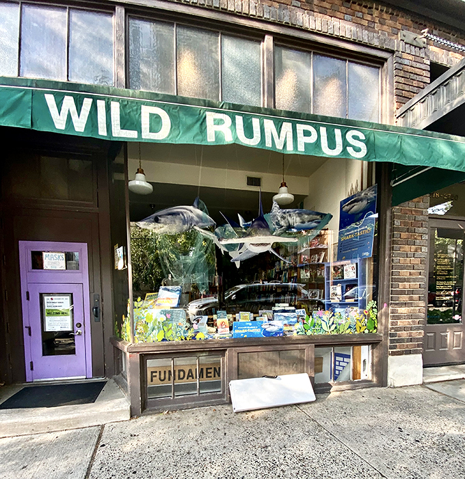 Welcome to Wild Rumpus, where books and adventure collide! This whimsical storefront, complete with a child-sized purple door, promises literary delights for all ages.