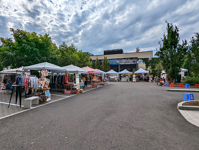 Welcome to Portland Flea, where vintage dreams come true! Colorful tents and eclectic crowds create a treasure hunter's paradise under the iconic Portland sky.