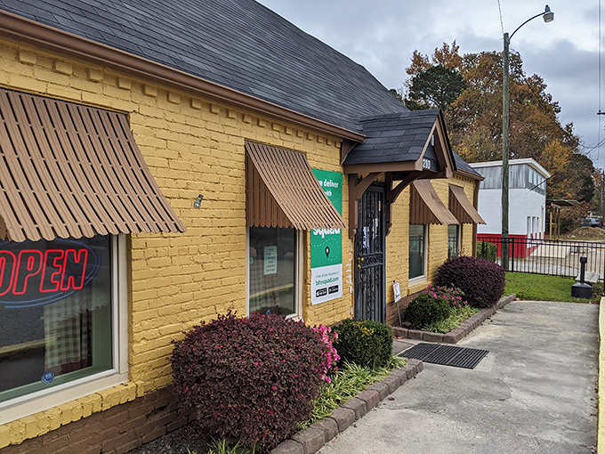 A sunny slice of Southern charm! This cheerful yellow building with its inviting brown awnings is like a warm hug for your taste buds.
