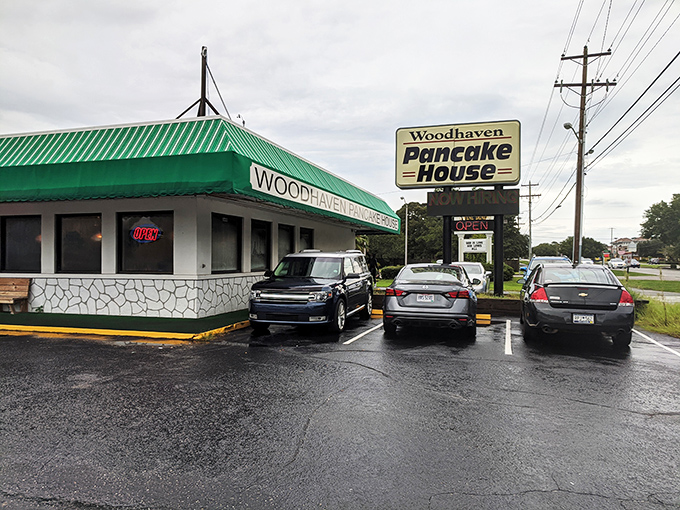A green-striped awning beckons like a breakfast lighthouse, guiding hungry souls to this unassuming pancake paradise. No frills, just thrills for your taste buds.