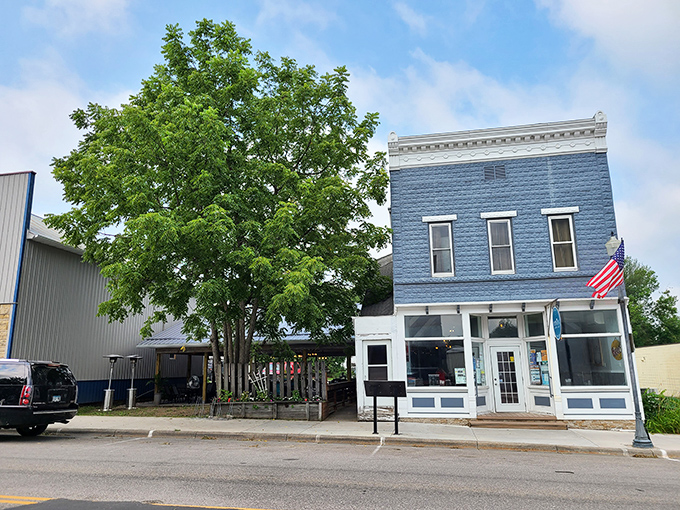 A slice of small-town charm: Estelle's blue sign swings like a pendulum, marking the spot where culinary magic happens in Harmony.