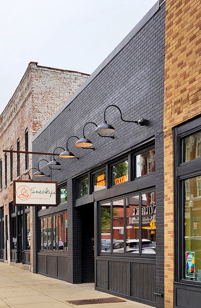 Welcome to Sneaky's, where the fox logo isn't the only clever thing you'll encounter. This charming storefront promises burgers and brews that'll make your taste buds do a happy dance.