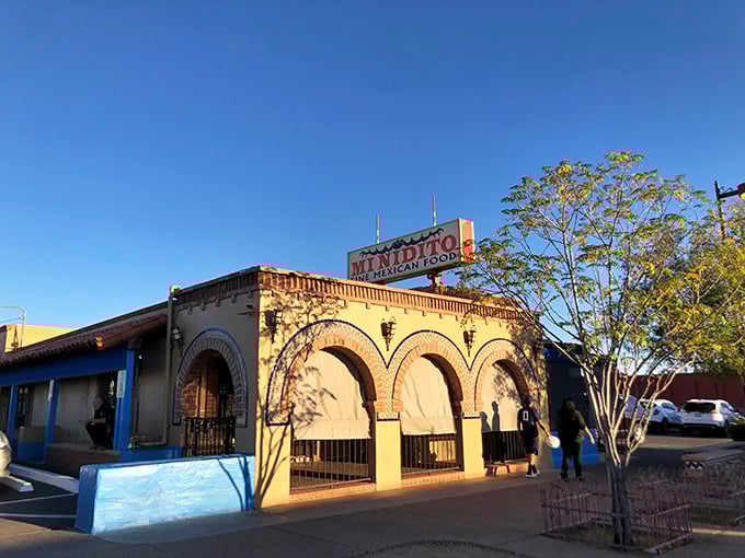 Welcome to flavor town! Mi Nidito's charming exterior promises a fiesta for your taste buds, with its inviting arches and sun-kissed facade.