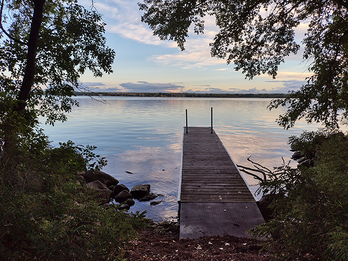 Big Stone Lake's serene beauty beckons. A wooden dock invites adventure, promising fishing tales and sunset views at Minnesota's hidden gem.