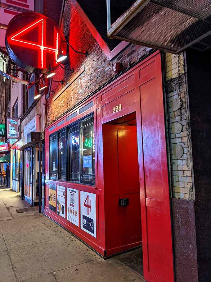 A neon beacon in the night, 4th Wall's red door beckons like a culinary Bat-Signal. Who needs the Batcave when you've got this?