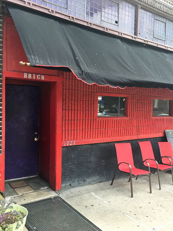 A red-brick beacon of deliciousness! The Brick's exterior promises a feast for the senses, with its vibrant facade and inviting purple door.