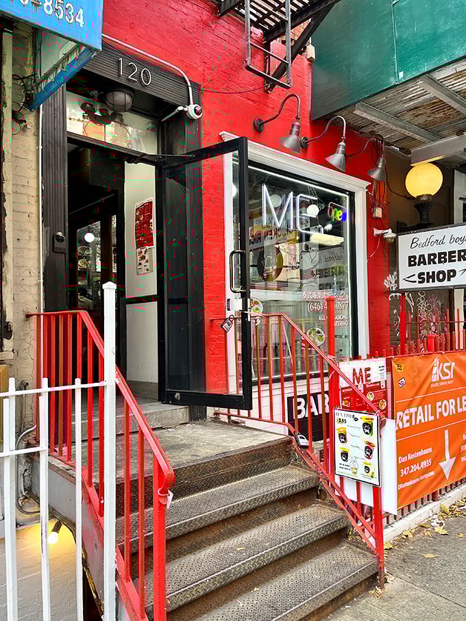 A splash of red in the urban jungle! This vibrant storefront promises a chicken adventure that'll ruffle your feathers in the best way possible.