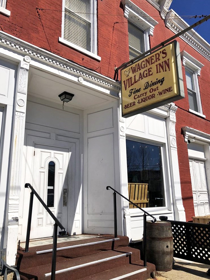 Step into a time warp! This red brick beauty, complete with a technicolor rooster, is like Norman Rockwell's dream come to life.