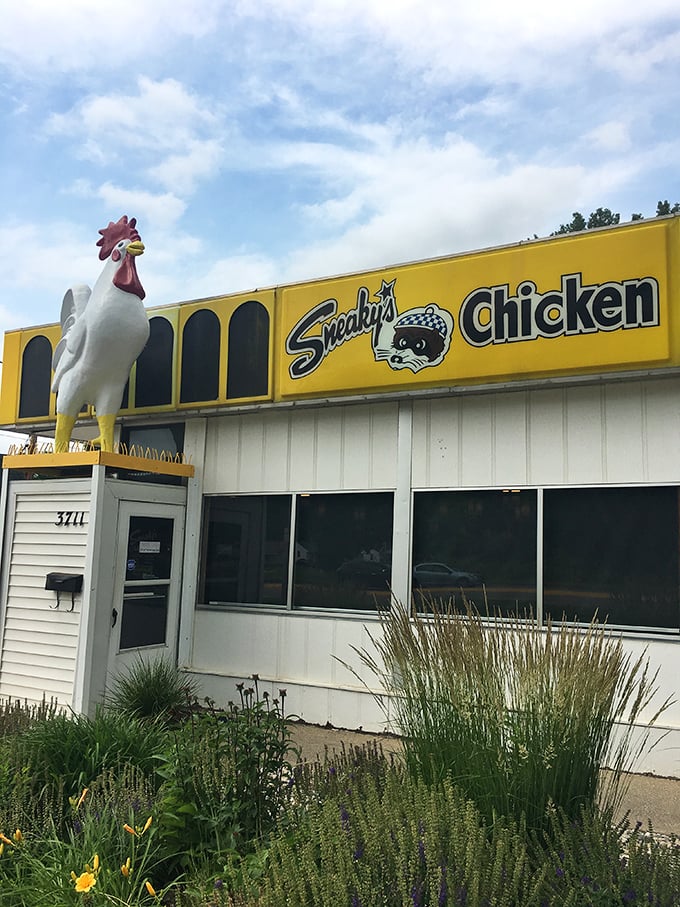Behold, the golden beacon of poultry perfection! Sneaky's Chicken stands proud, its vibrant yellow exterior a siren call to hungry souls seeking crispy comfort.